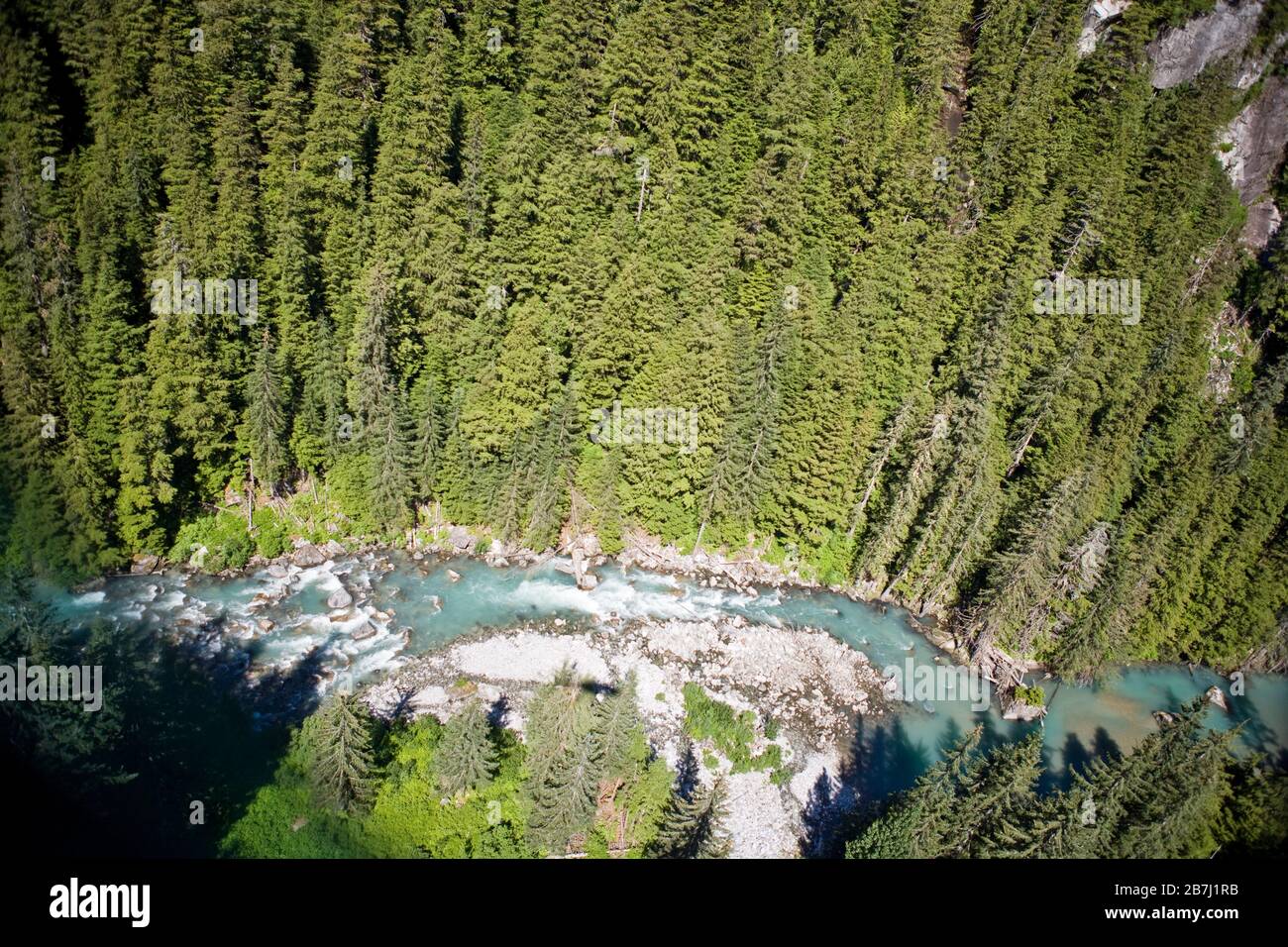 River running through forest in valley Stock Photo - Alamy