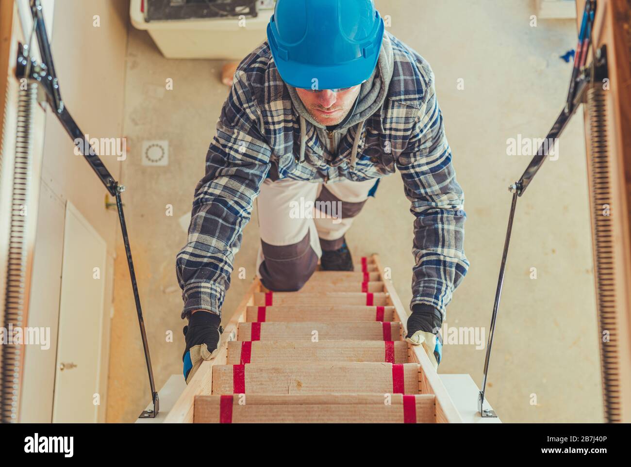 Construction Worker Walking Upstairs To Take a Look at House Attic ...