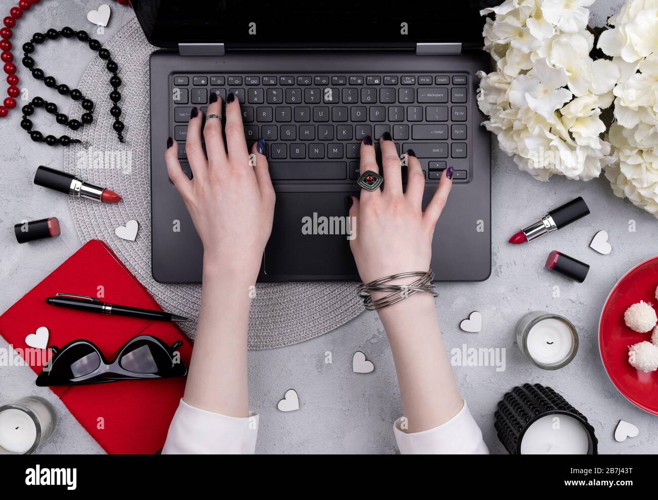 Beautiful groomed woman's hands typing at keyboard on the home office ...