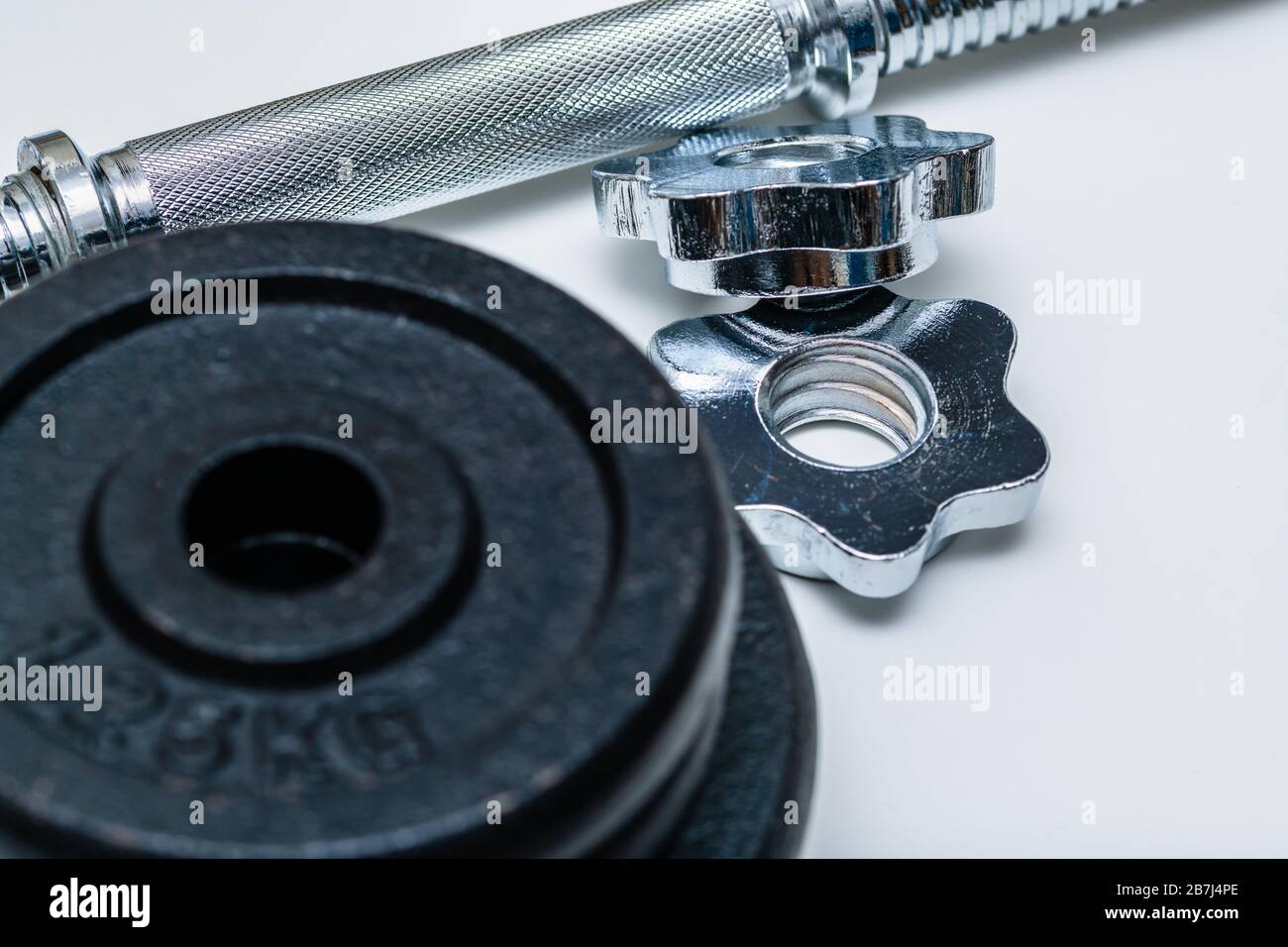 Close-up of four black weight training weights out of focus stacked ...