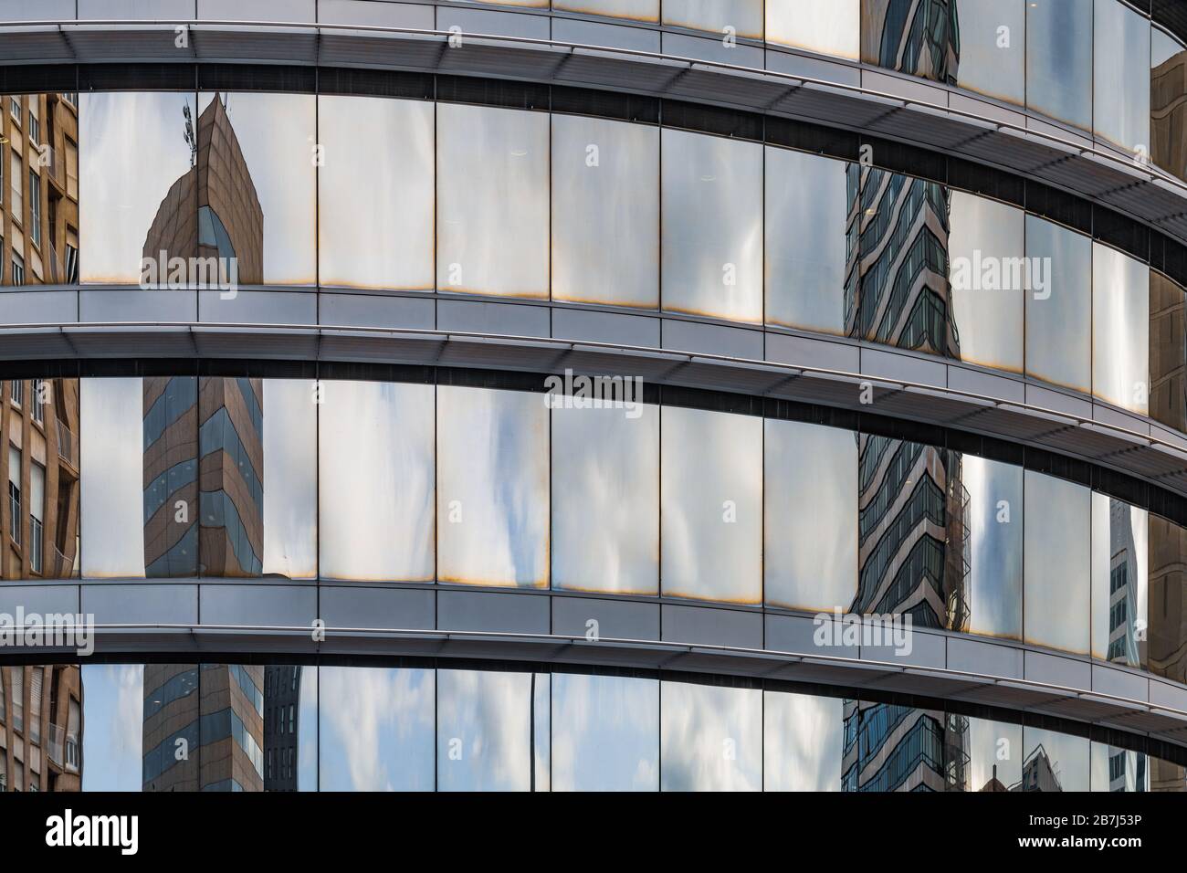 Light reflections on the curved glass of the windows of an office ...