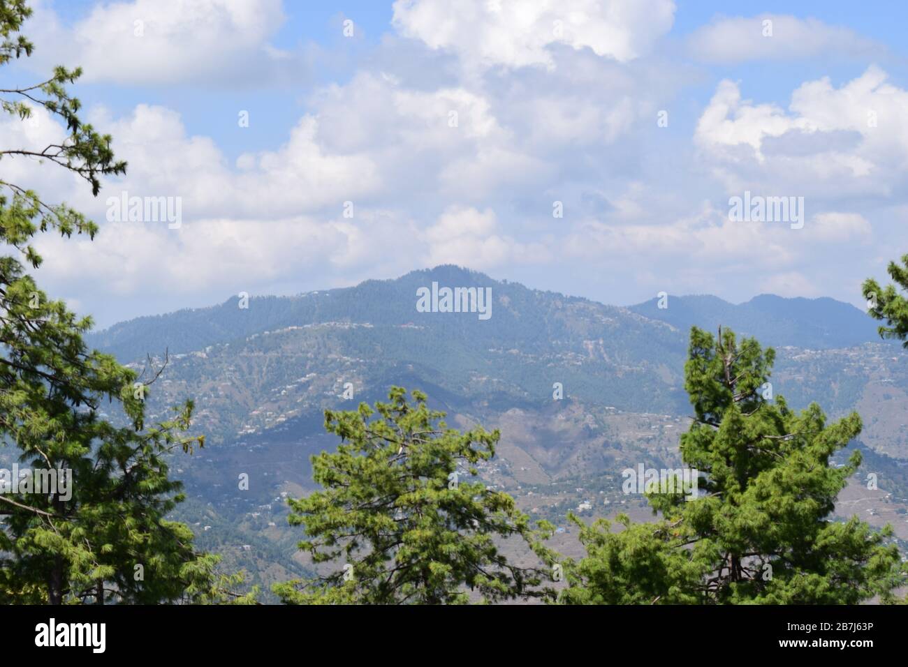 Beautiful green mountains with blue sky, clouds and trees Stock Photo ...