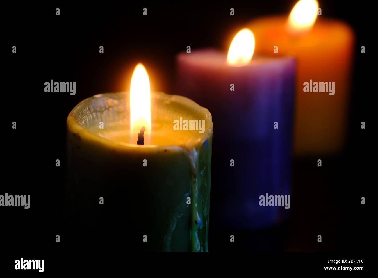multi color Candles Burning in the Dark Stock Photo - Alamy
