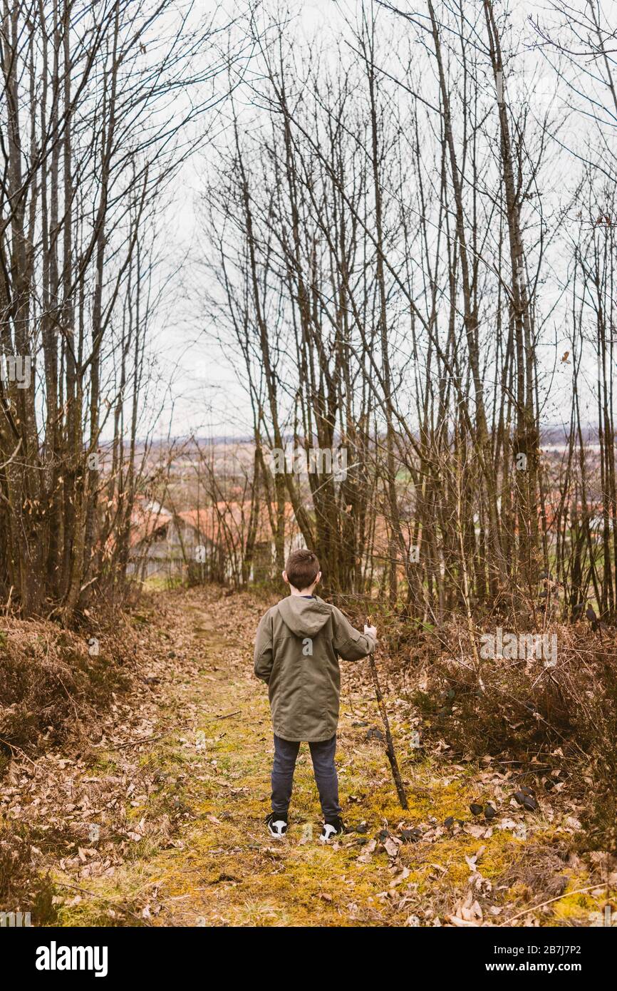 Young boy standing in the nature Stock Photo - Alamy