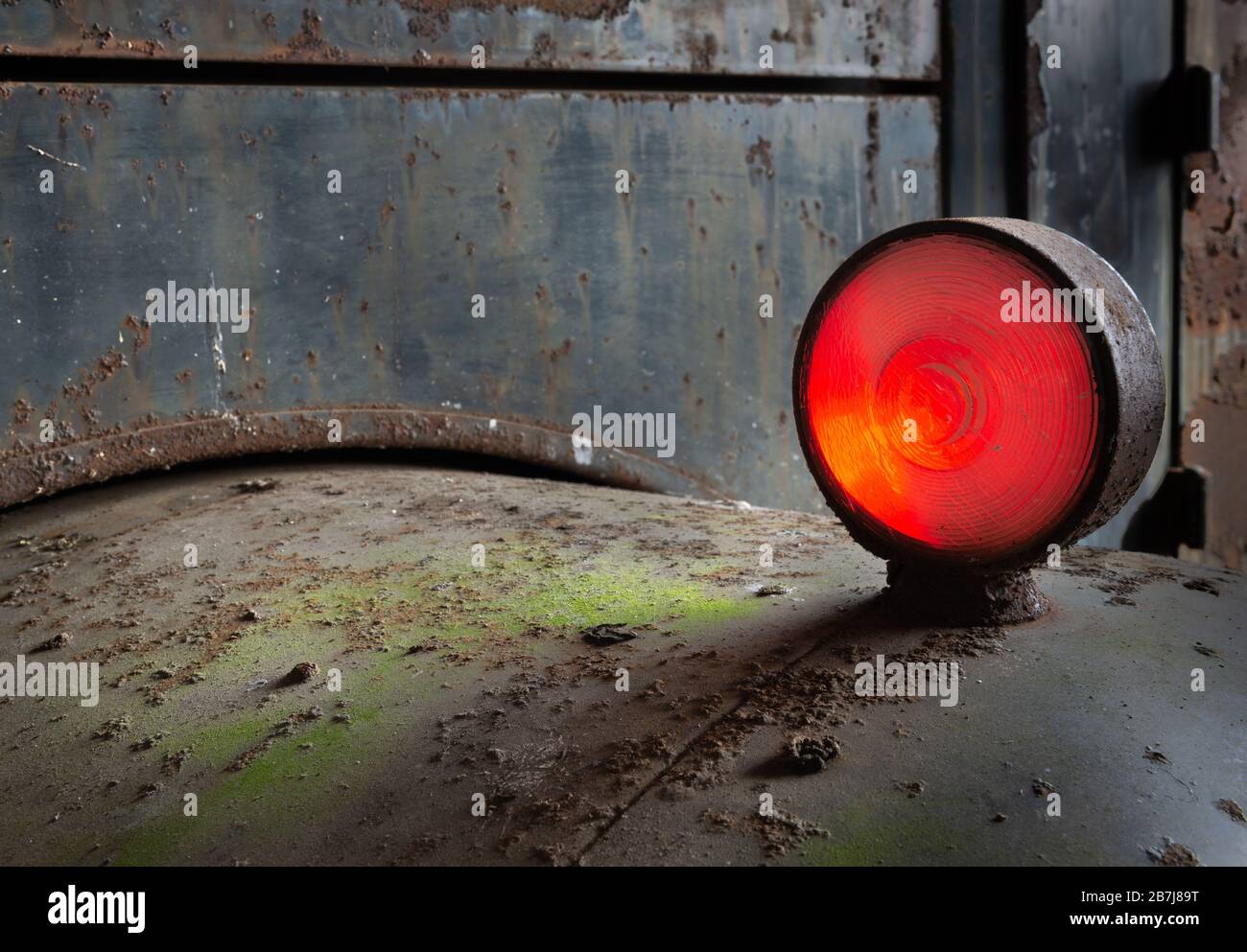 Turn signal light on fender of old abandoned truck. Light shining ...