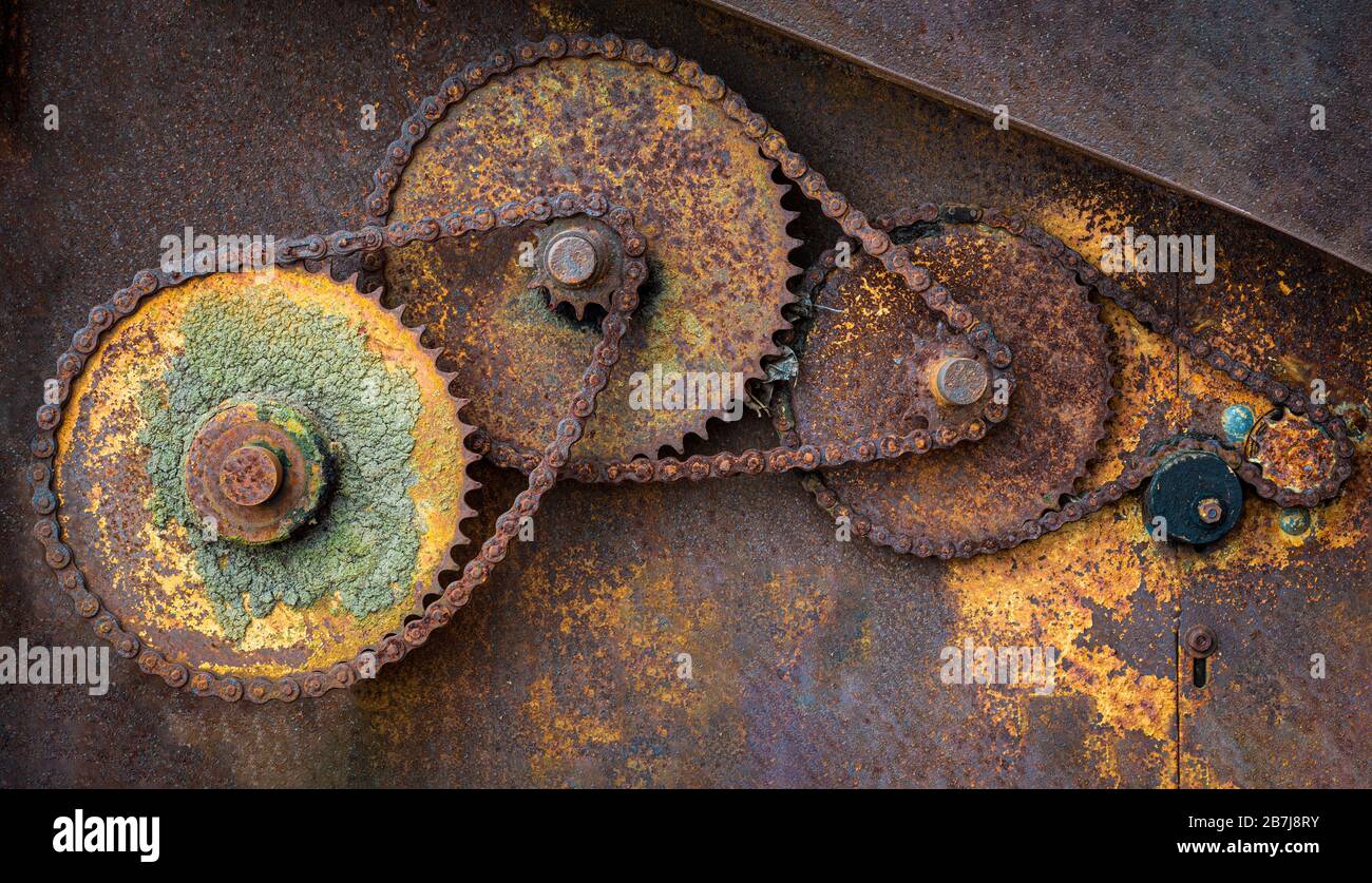 Gears and chains on old abandoned farm equipment Stock Photo - Alamy