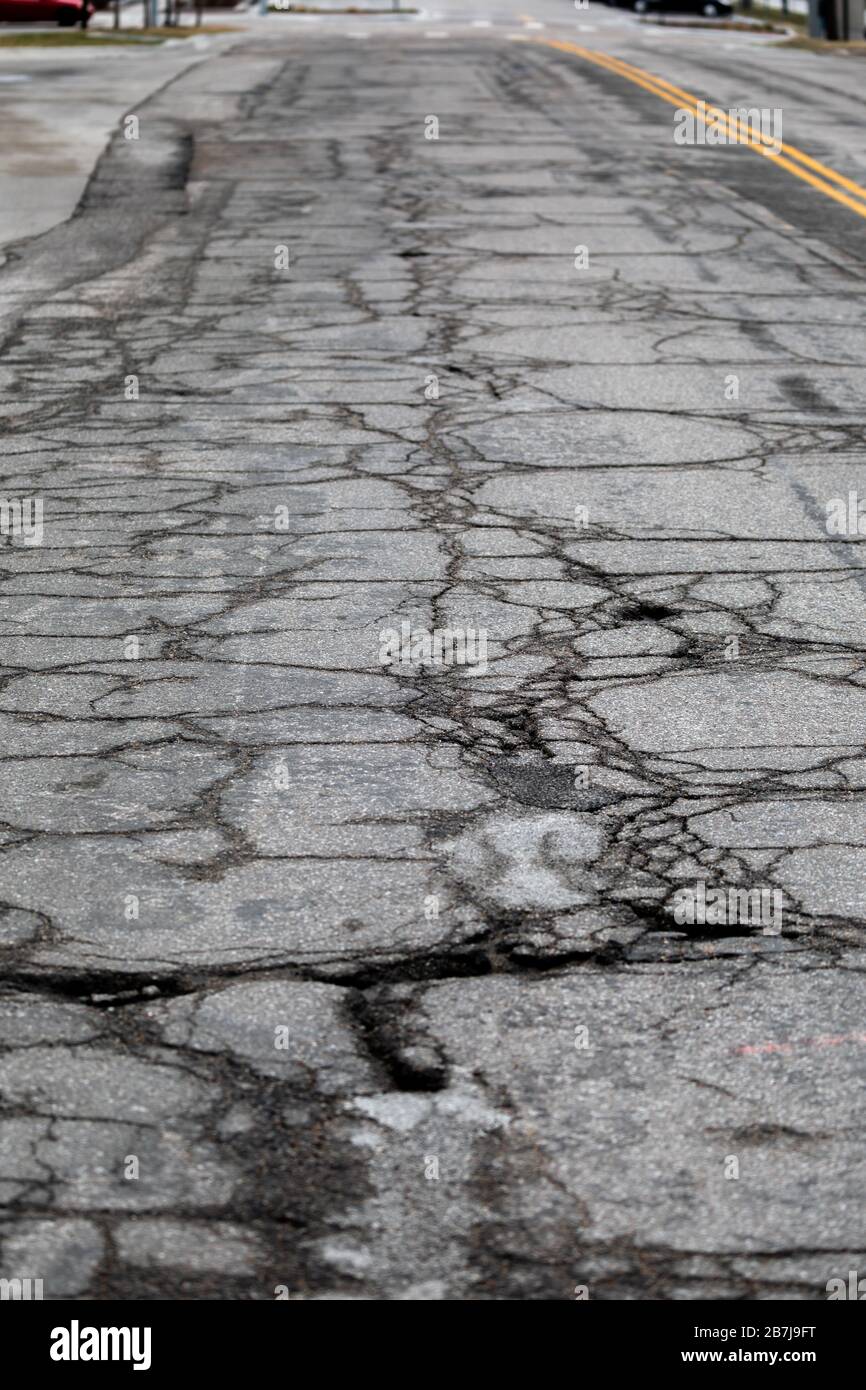 Cracked and damaged road surface Stock Photo - Alamy
