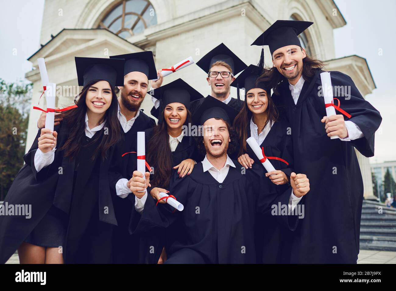 A group of graduates smiling Stock Photo - Alamy