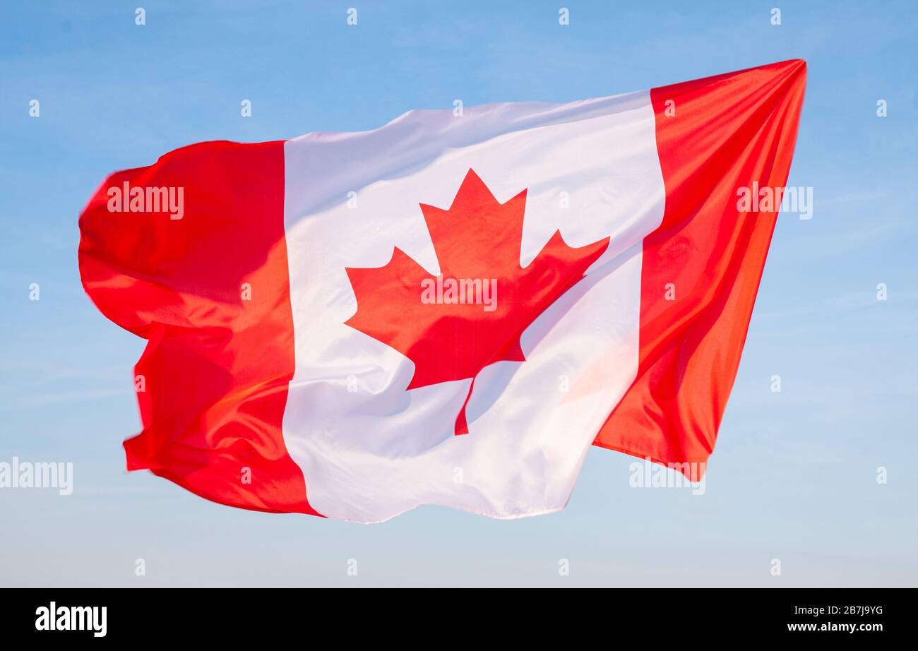 National Flag of Canada. Canadian flag on blue sky background Stock ...