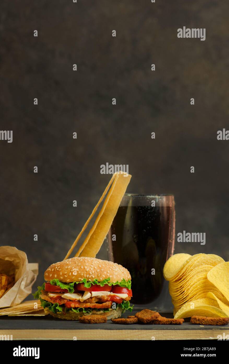 Delicious hamburger with fries, snacks and chips. Mix of snacks. Yummy ...
