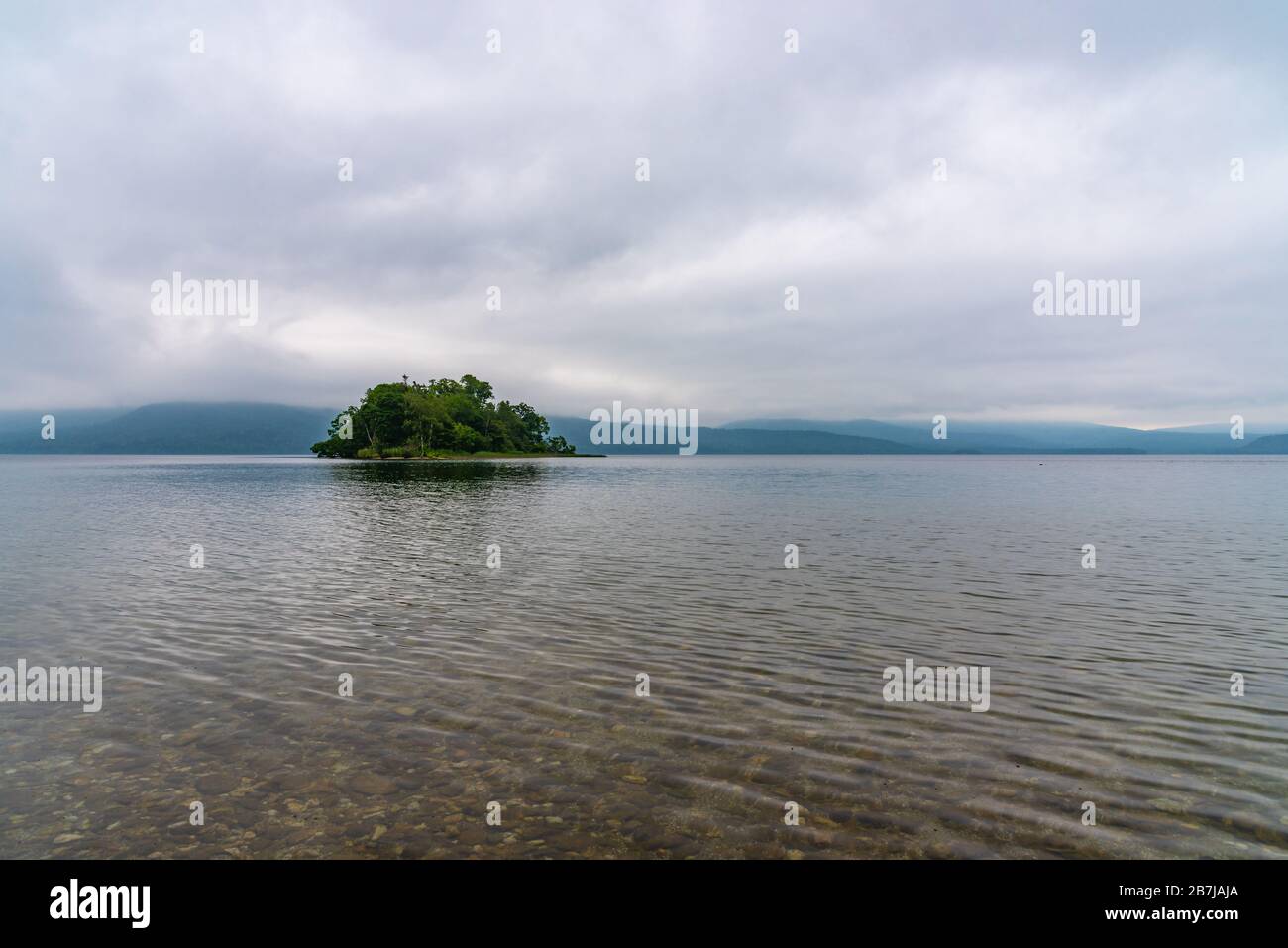 One small island on a water surface Stock Photo - Alamy