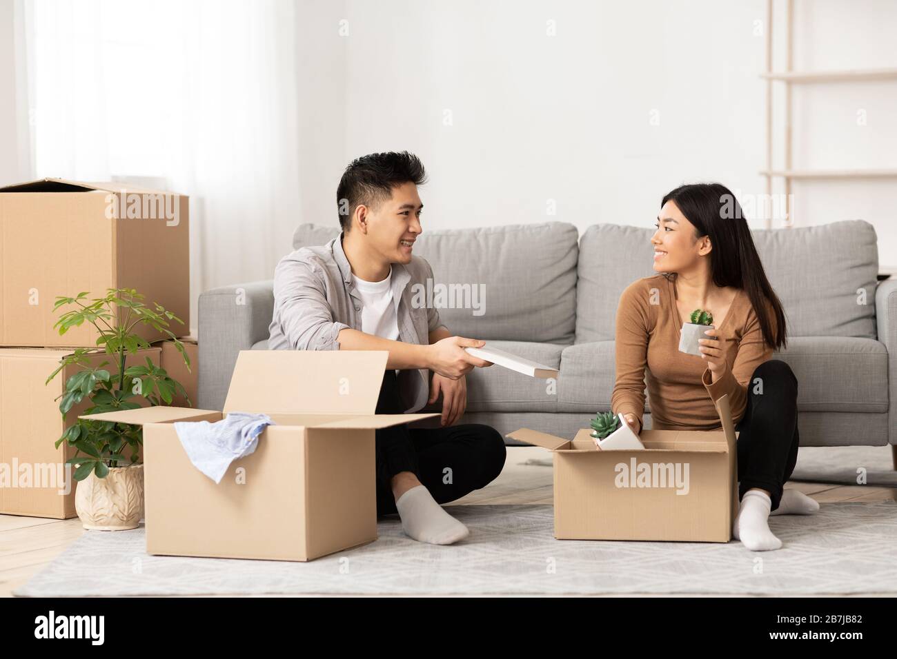 Asian man packing boxes hi-res stock photography and images - Alamy