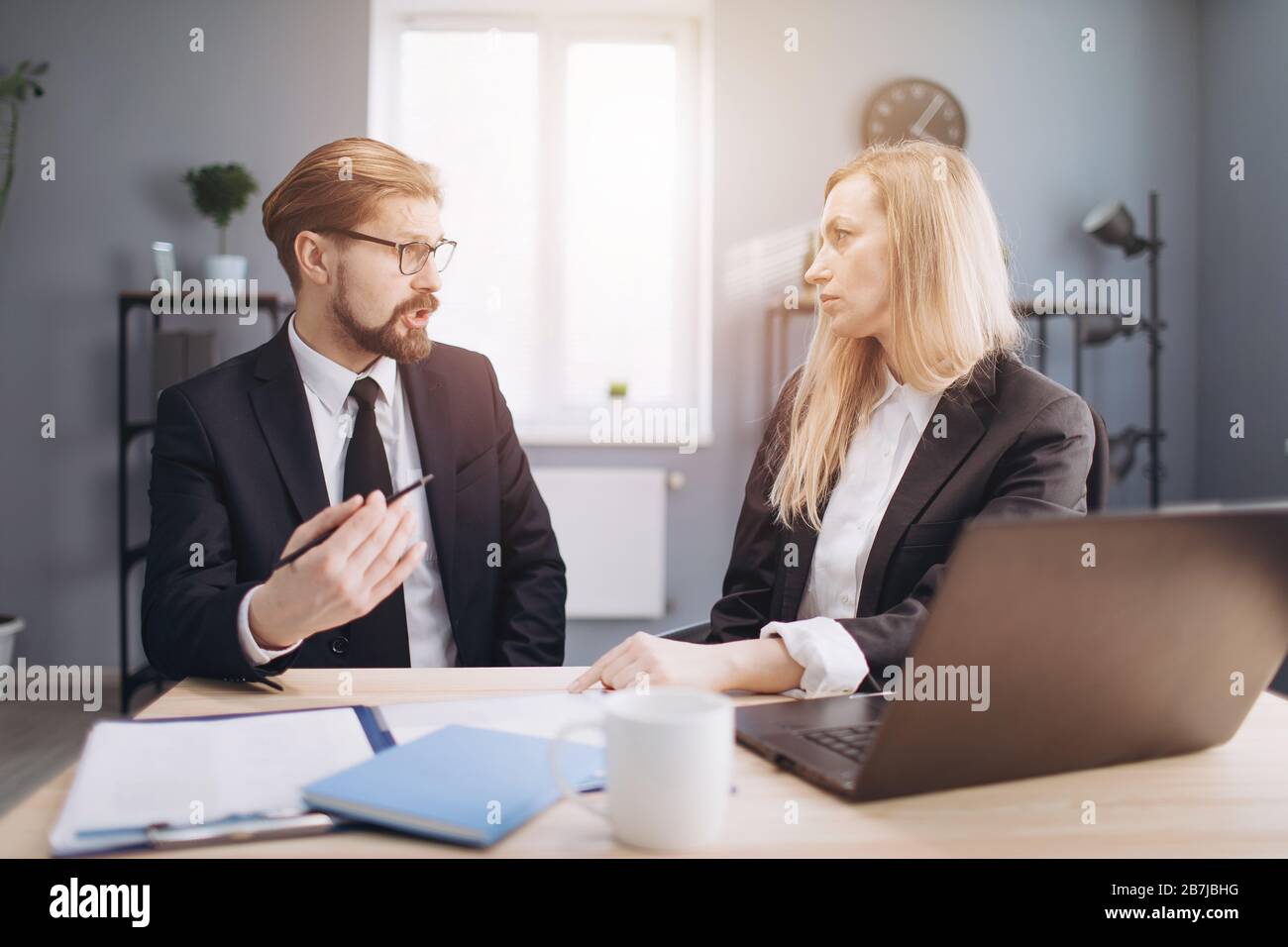 Two business partners discussing new project at work Stock Photo - Alamy