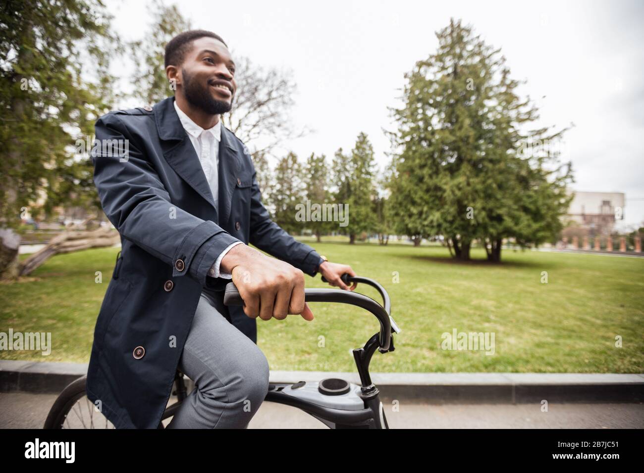Businessman riding bicycle in park hi-res stock photography and images ...