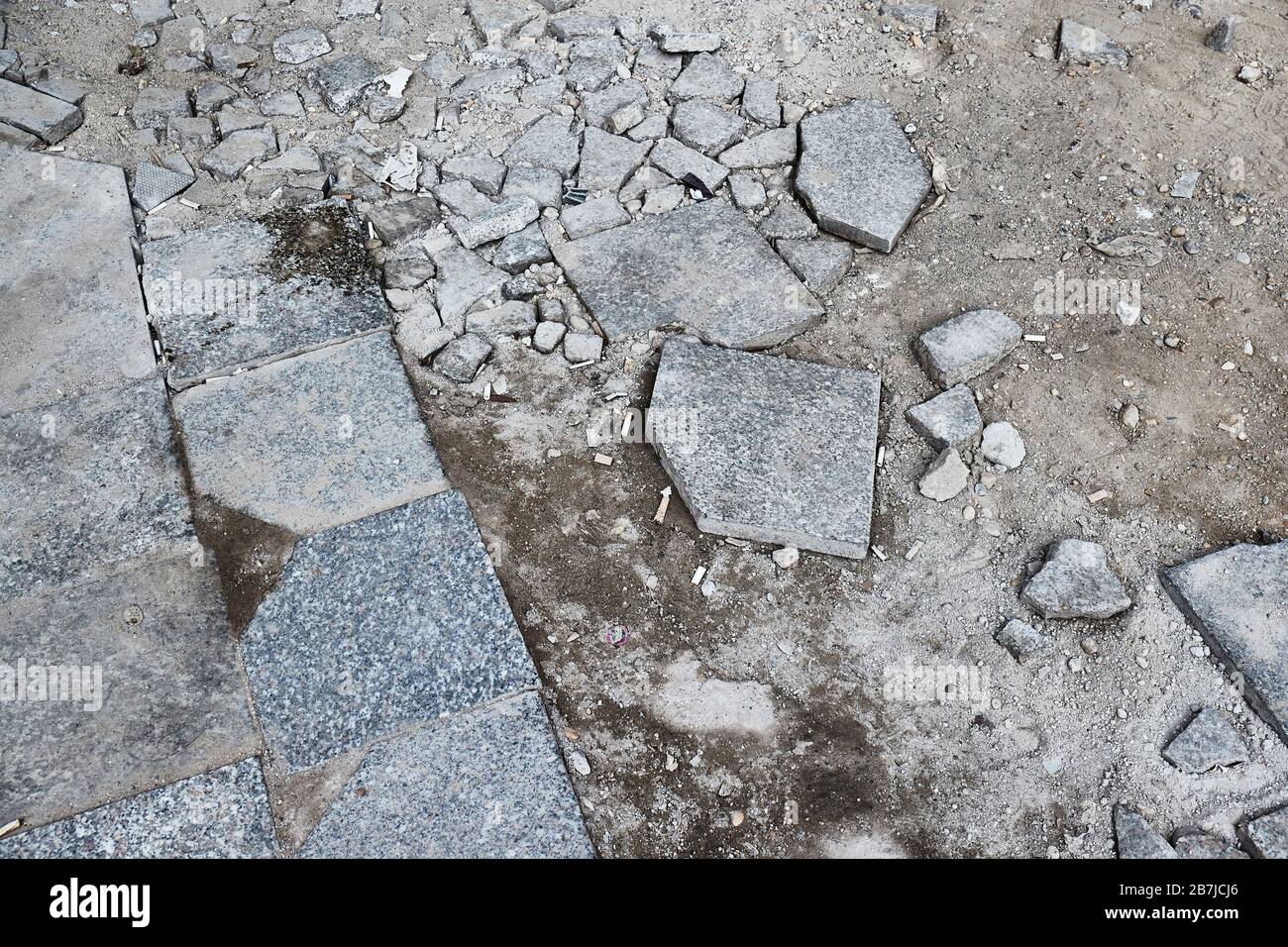 Stone pavement broken near construction Stock Photo - Alamy