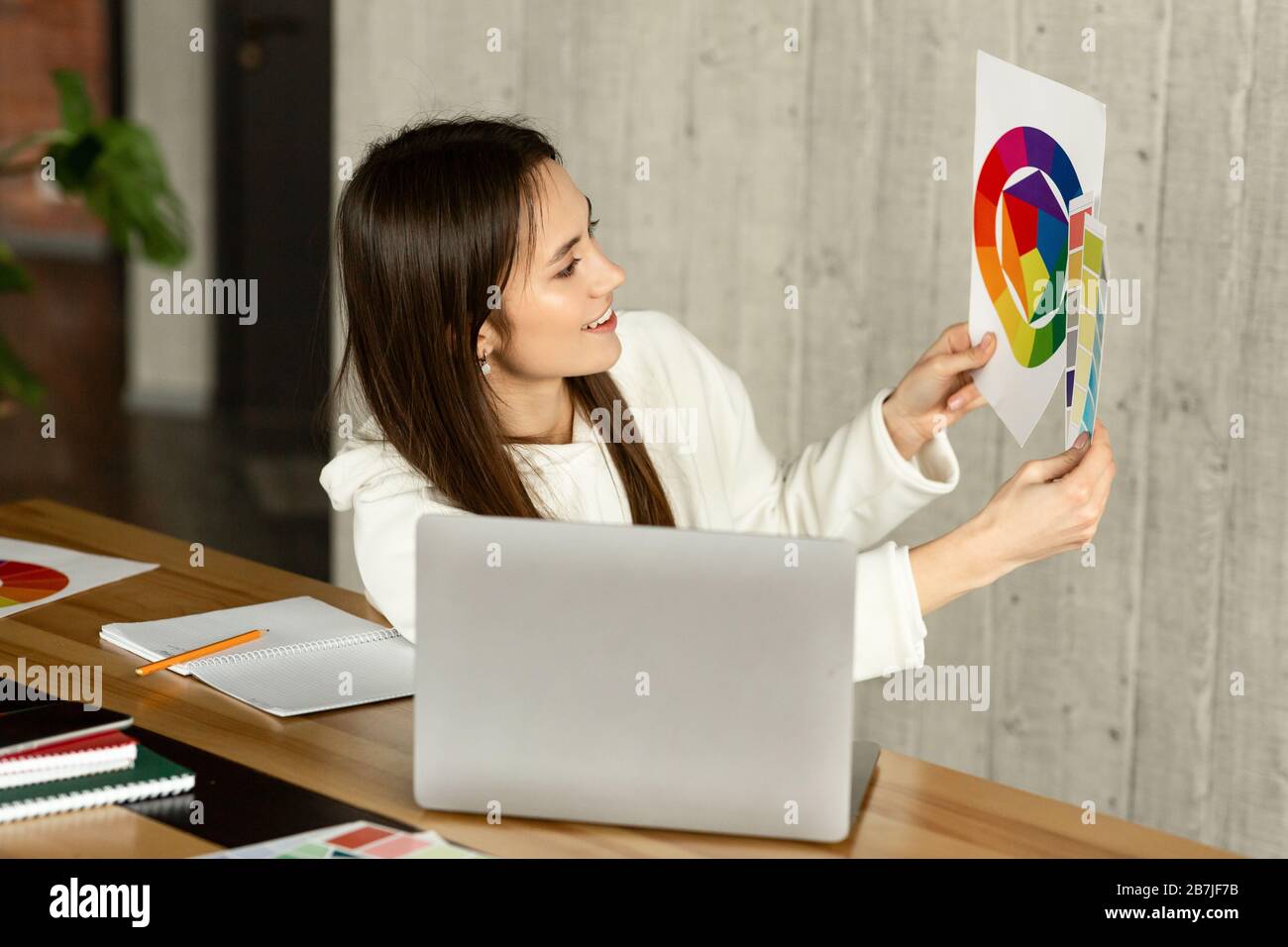 Remote work concept. Designer demonstrates color swatch Stock Photo - Alamy
