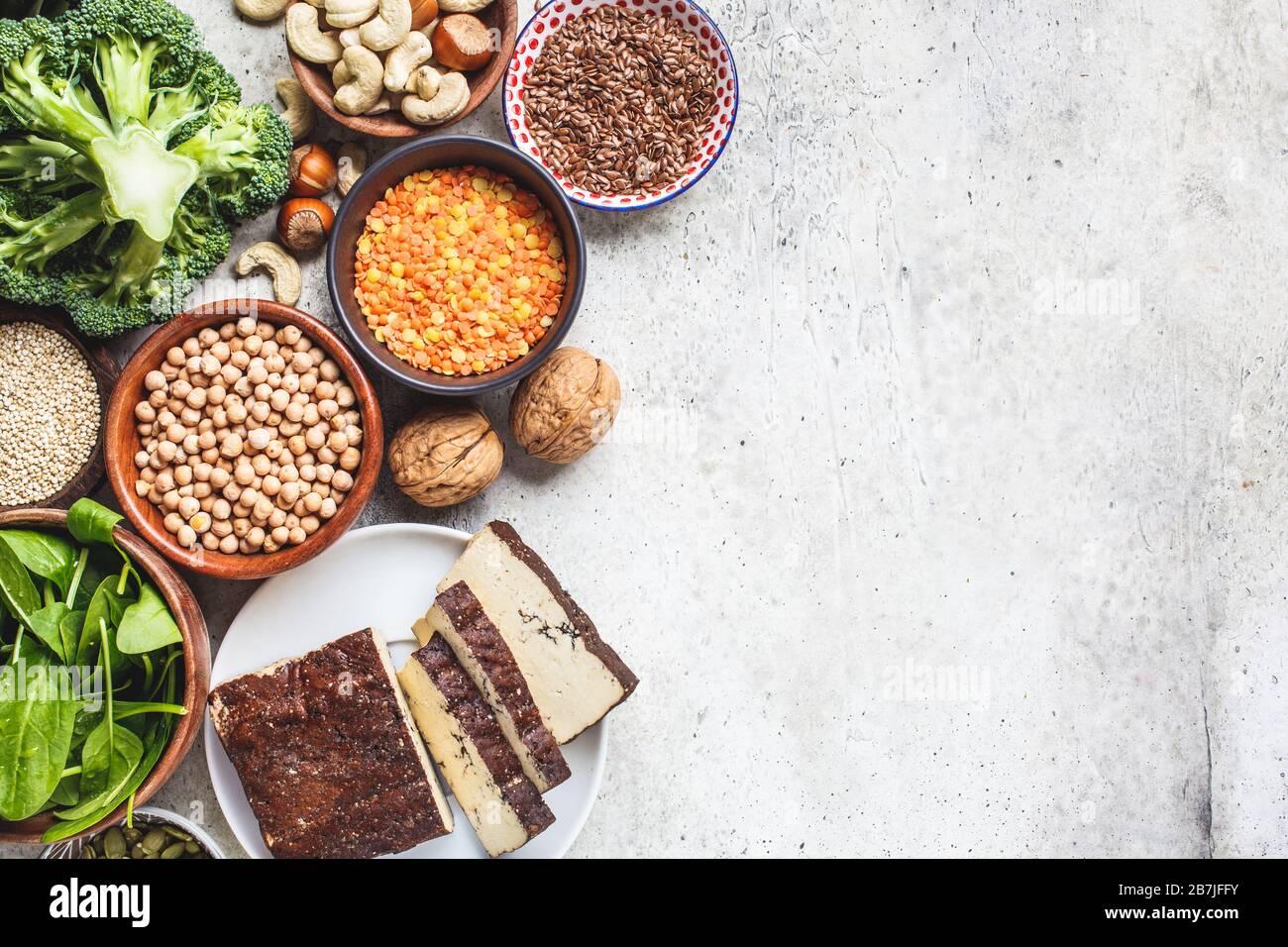 Vegan sources of protein background, top view. Tofu, chickpeas, lentils ...