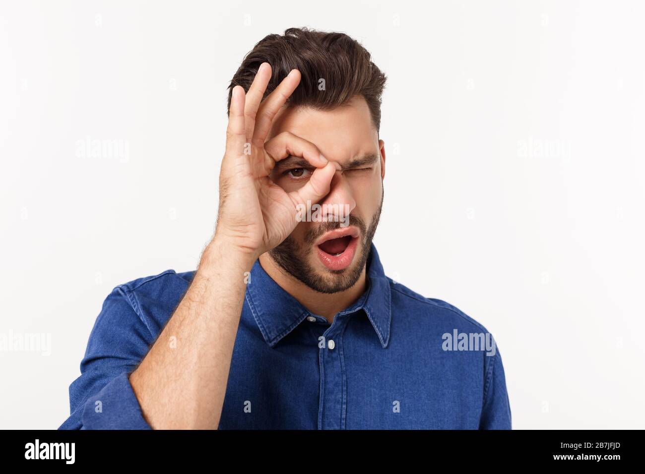 Young handsome man with beard doing ok gesture shocked with surprised ...