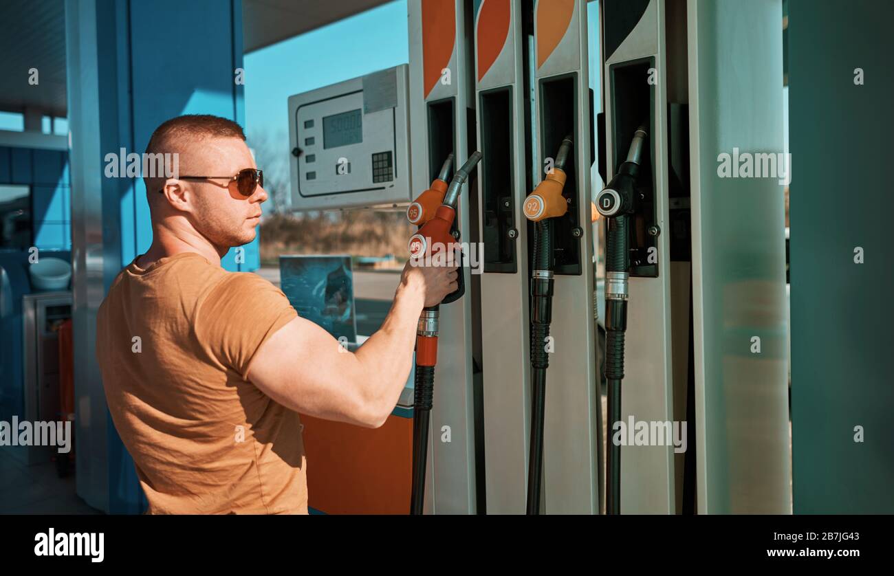 Man fueling his car at a self service petroleum gas station hi-res ...