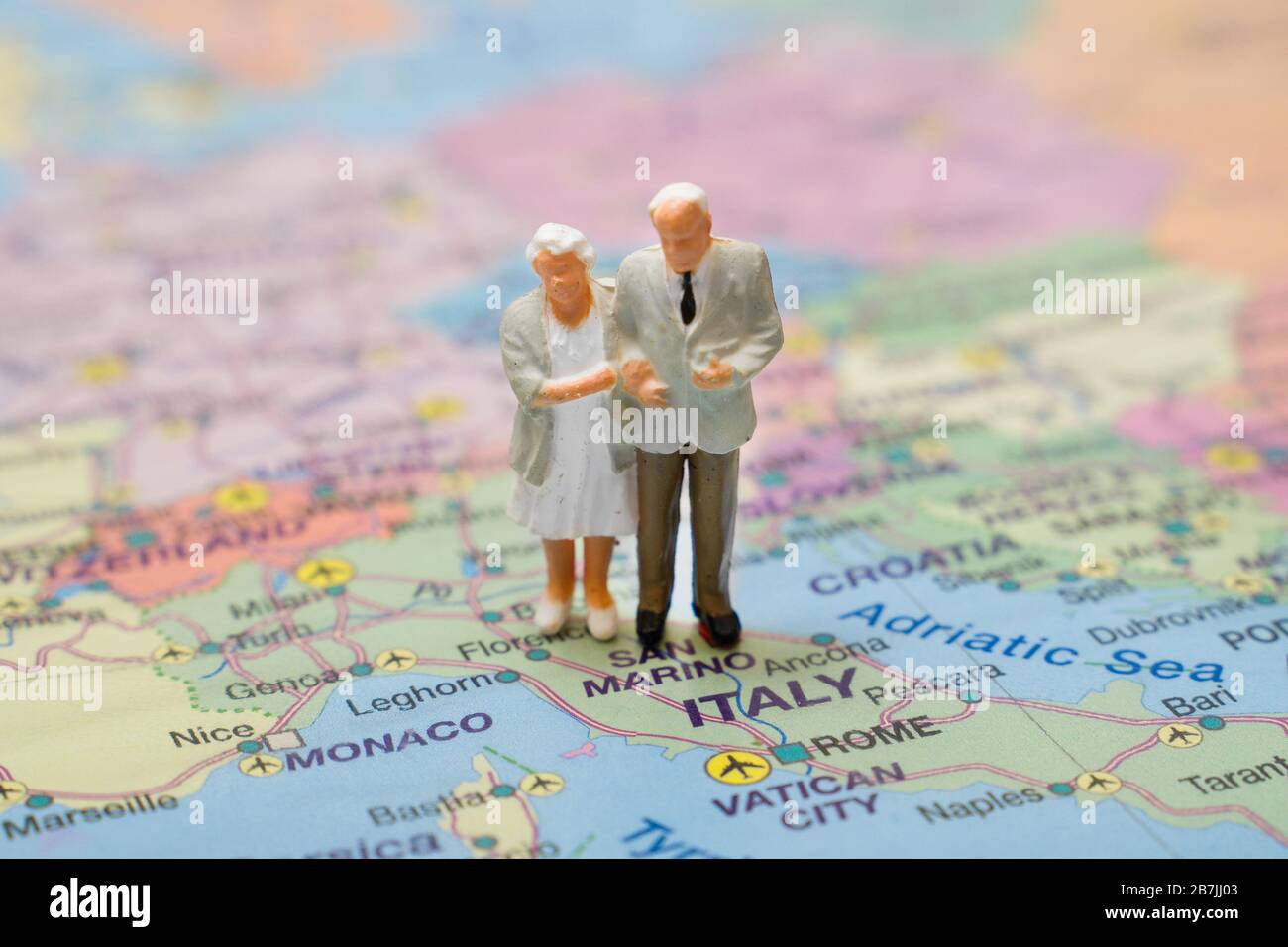 Figures of the elderly couple on a map of Italy Stock Photo - Alamy