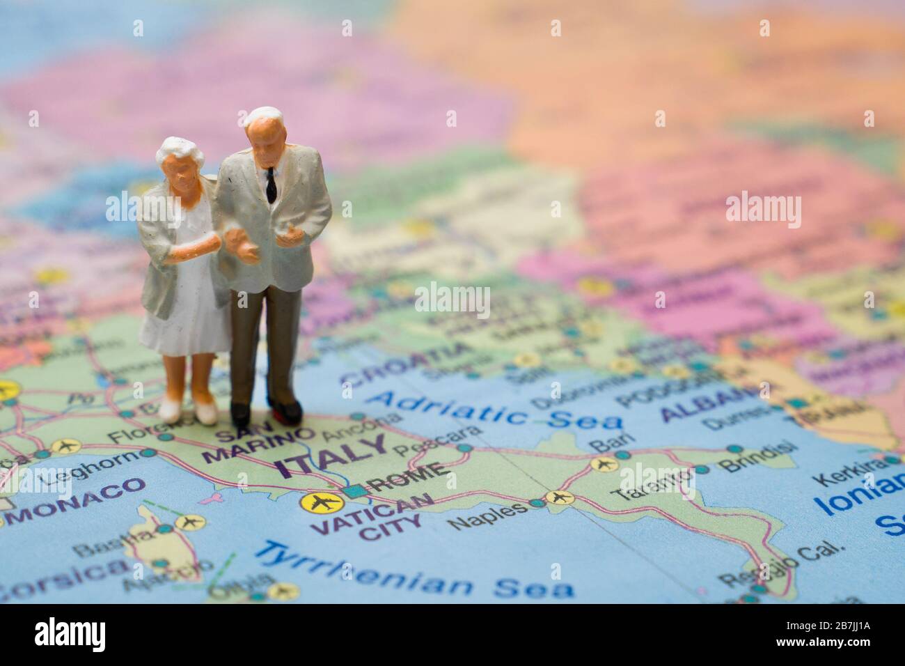 Figures of the elderly couple on a map of Italy Stock Photo - Alamy
