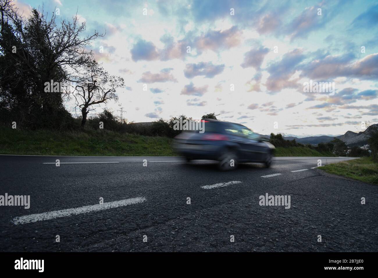 Highway at dawn with car at speed Stock Photo - Alamy