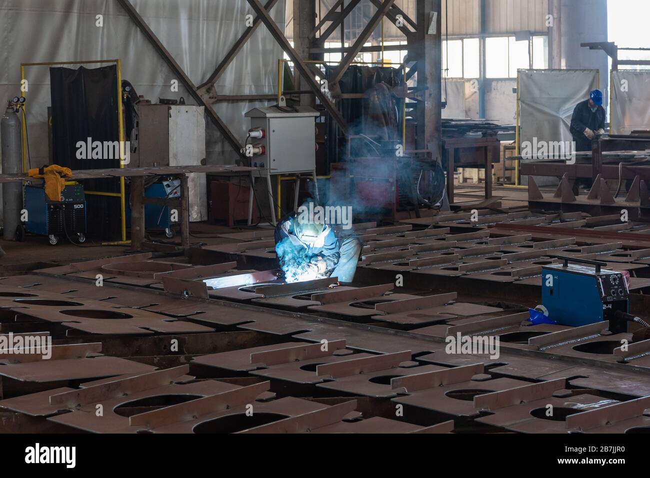 shipyard workers are working in the hangar to build a new ship Stock ...