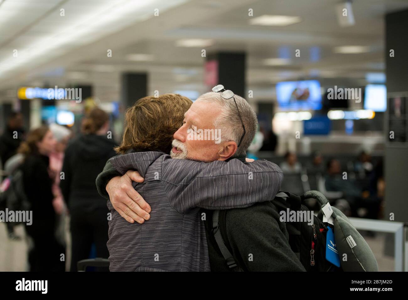 A man is embraced after arriving from Dubai on a 14-hour flight on ...