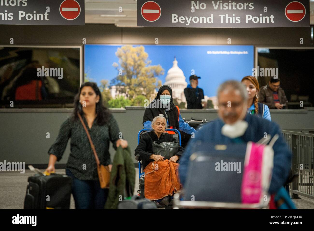 Passengers arrive from Dubai after a 14-hour flight on Emirates flight ...