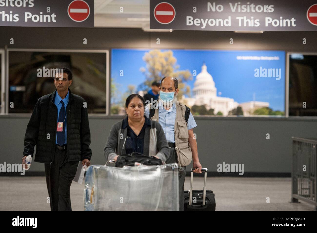 Passengers arrive from Dubai after a 14-hour flight on Emirates flight ...