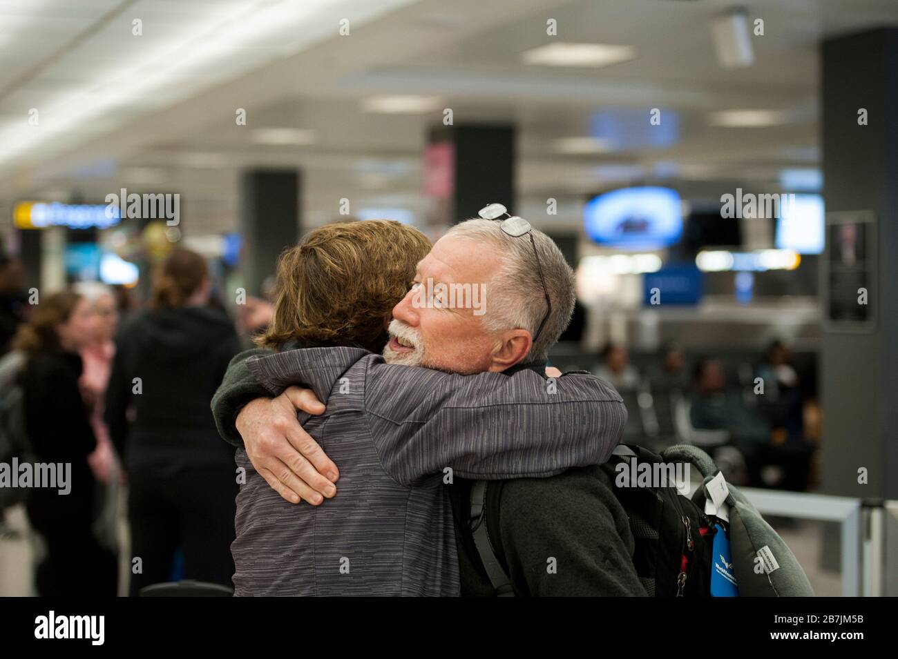 A man is embraced after arriving from Dubai on a 14-hour flight on ...