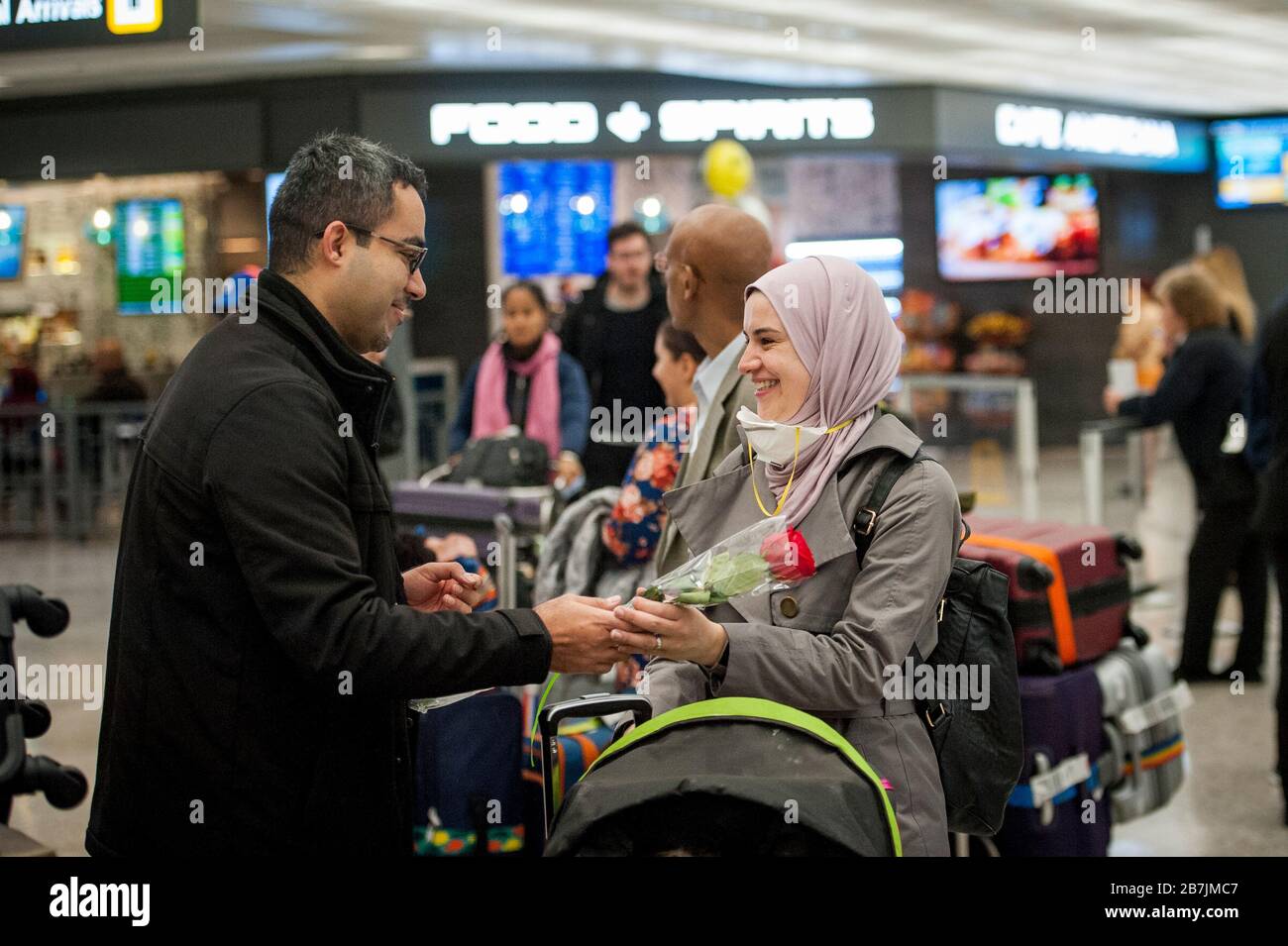A family is united as passengers arrive from Dubai after a 14-hour ...