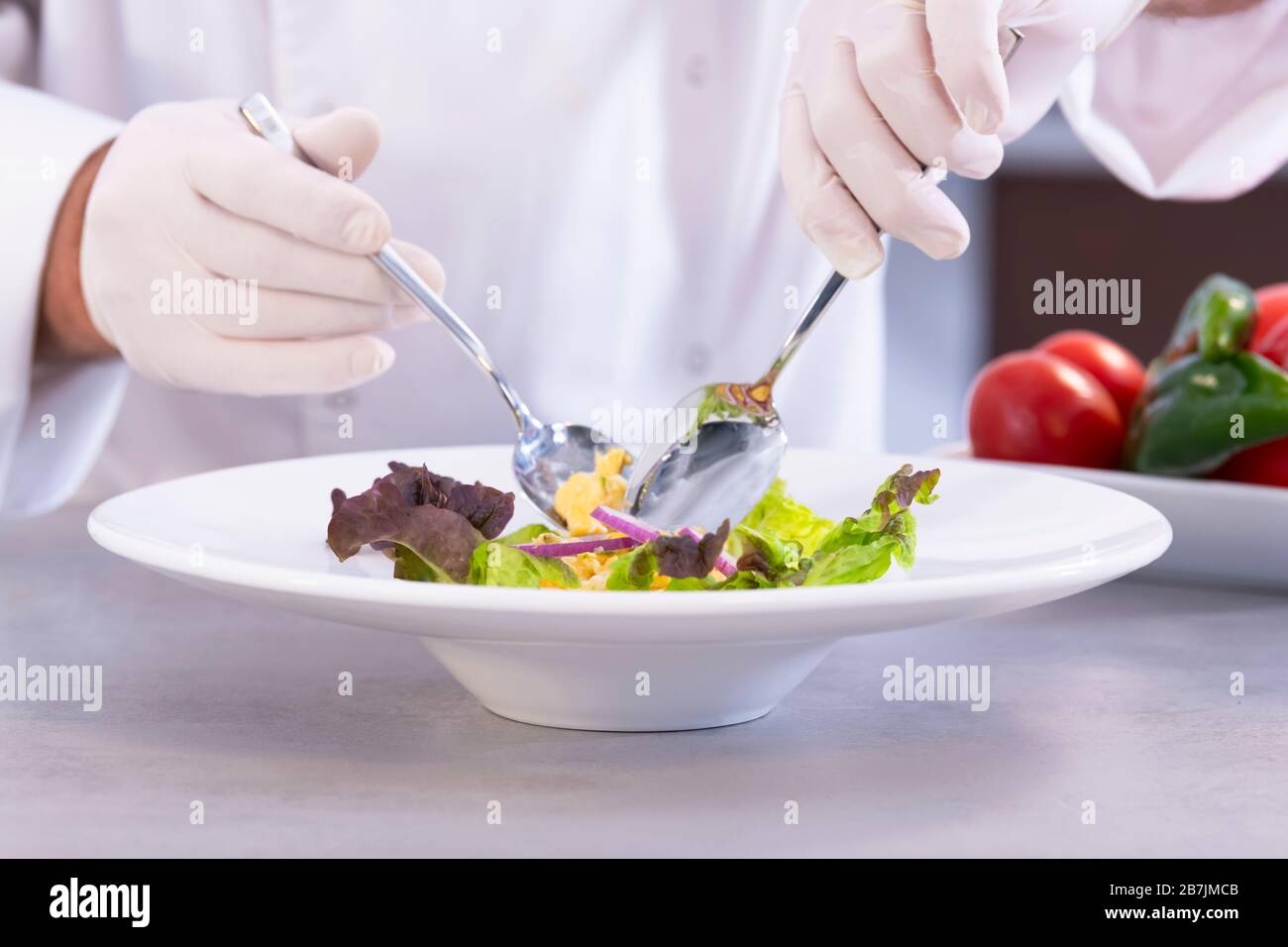 Chef using spoons to prepare a delicious salad Stock Photo - Alamy