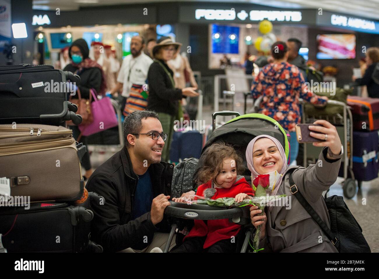 A family is united and takes a selfie, as passengers arrive from Dubai ...