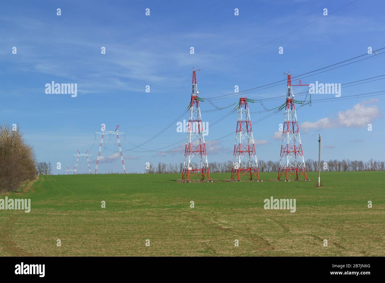 Supports power lines are in the field. Red and white. New line Stock ...