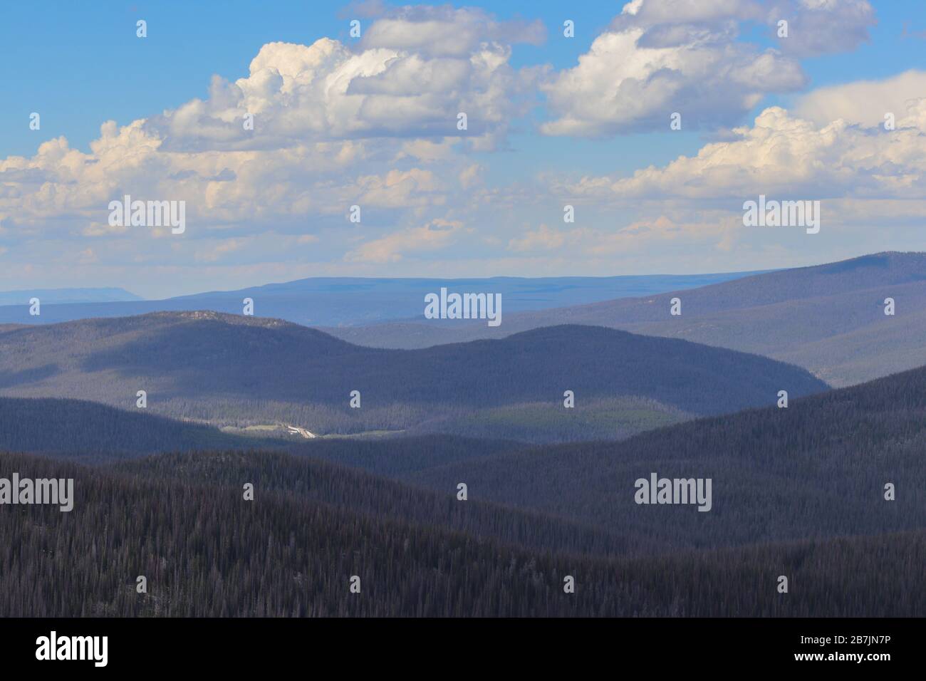 Colorado mountain peaks with blue cloudy skies above Stock Photo - Alamy