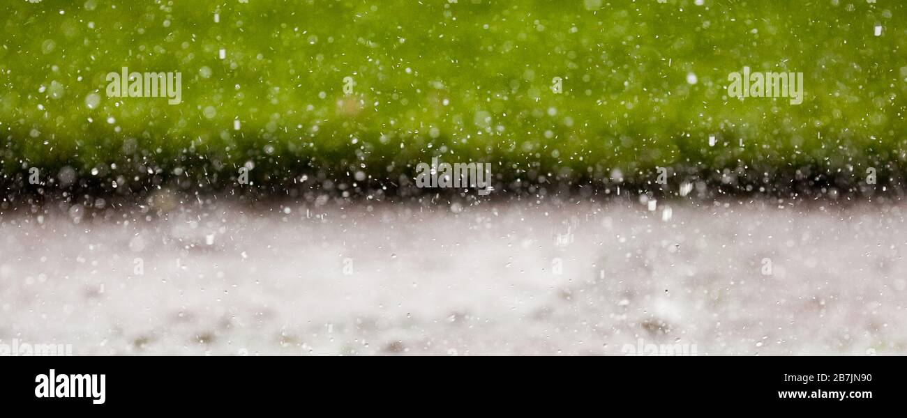 Heavy rain splashing in a puddle Stock Photo - Alamy