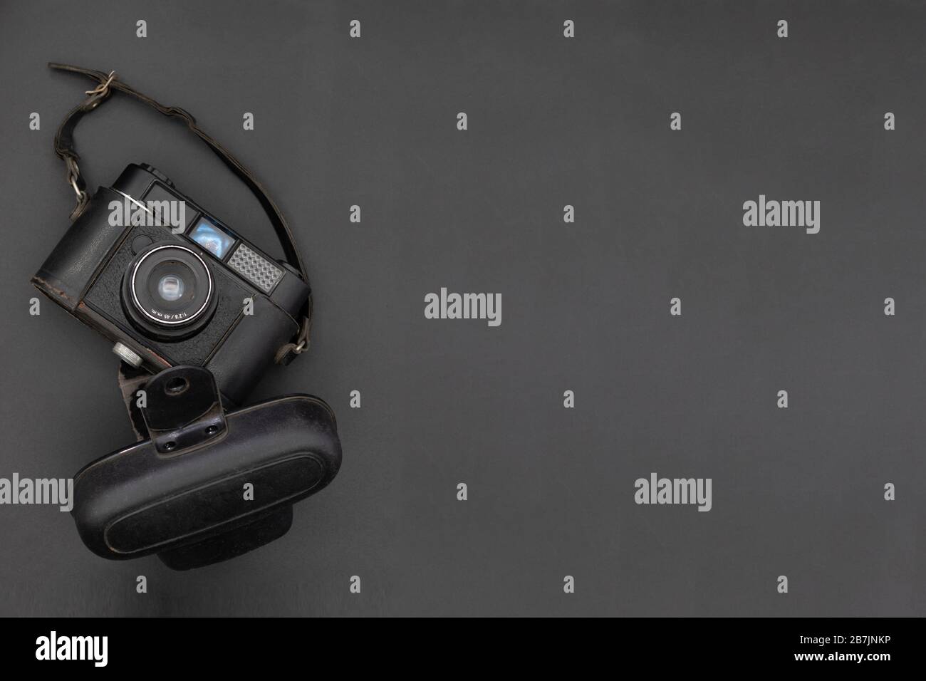 Horizontal image of an old camera from the 60s with its leather case on ...