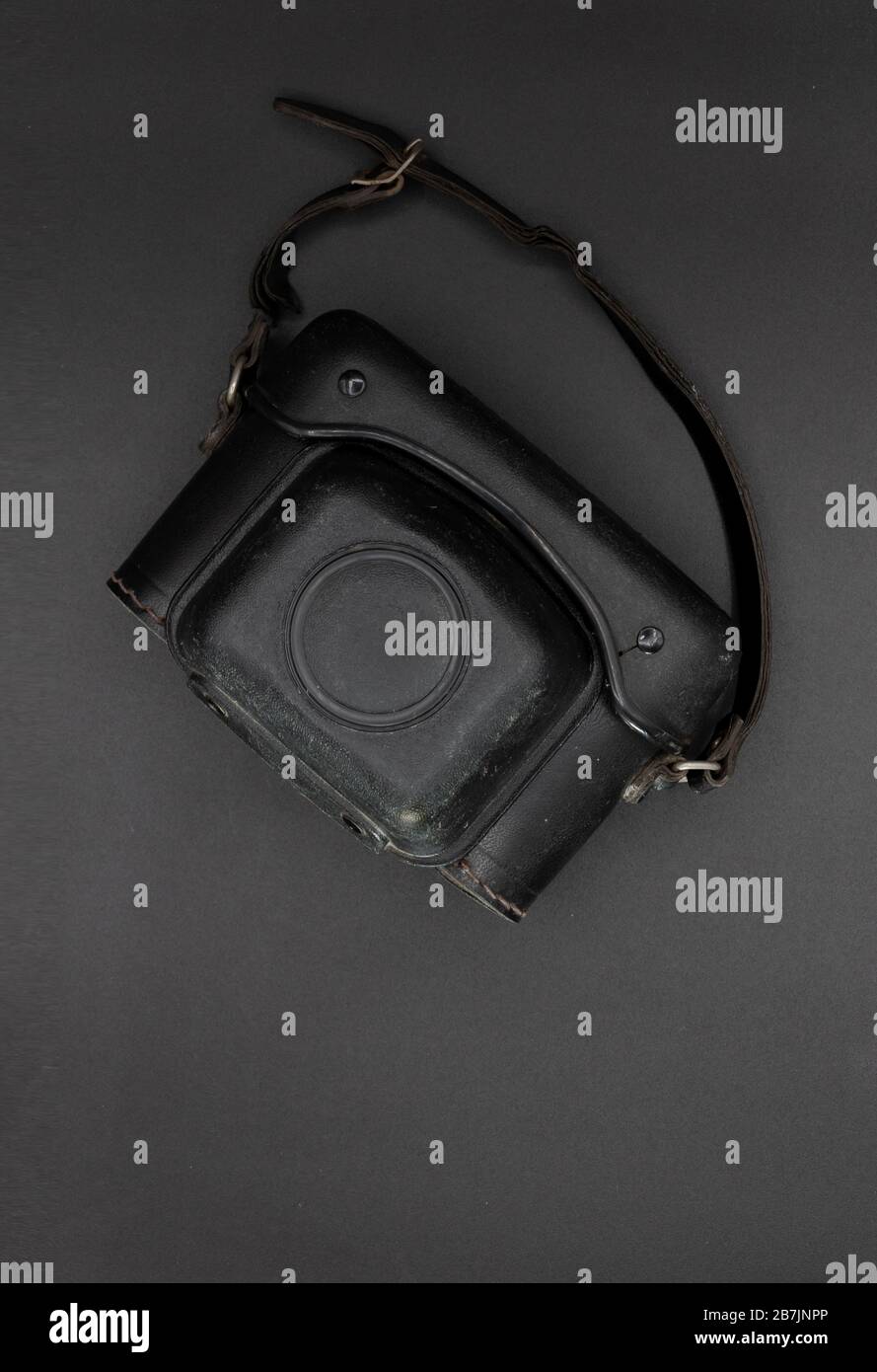 Old camera inside its worn leather case on dark background. Photography ...