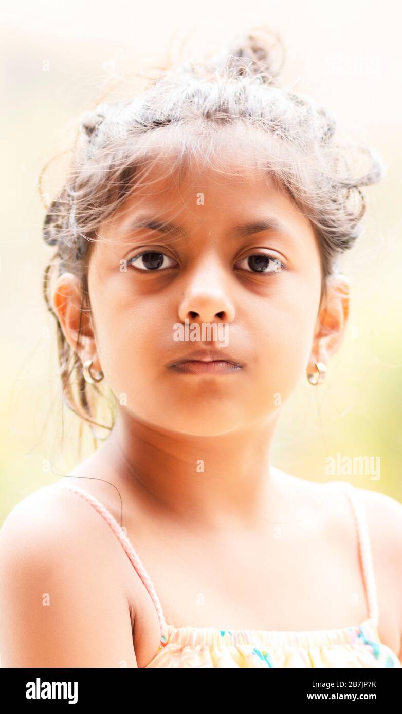 Portrait of cute little girl showing her beautiful face Stock Photo - Alamy