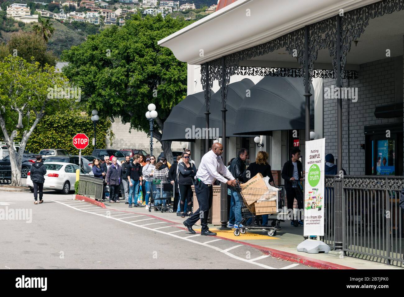 Line of shoppers wait outside a grocery store to prepare for corona ...