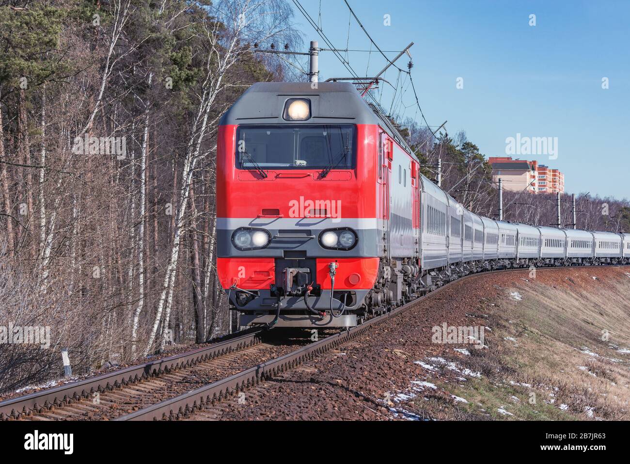 Passenger train approaches to the station Stock Photo - Alamy