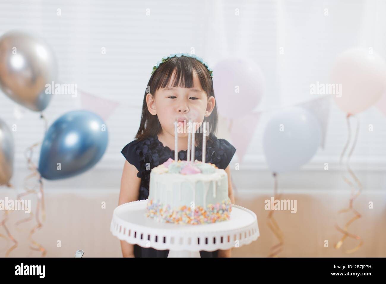 toddler girl celebrating her 4th birthday at home Stock Photo - Alamy