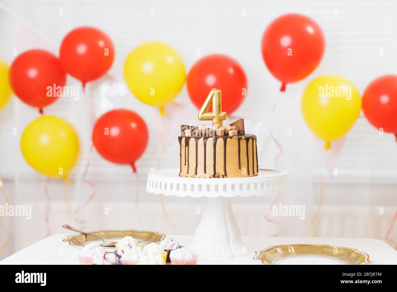 birthday cake with number 4 on cake stand Stock Photo - Alamy