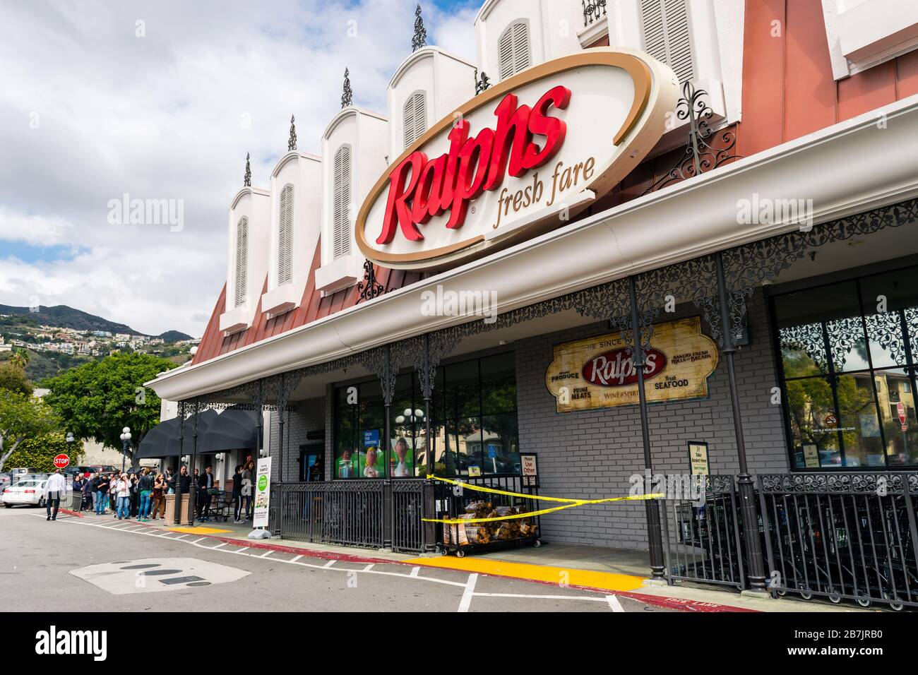 Outside Ralph's grocery store, a line of shoppers forms to stock up for ...