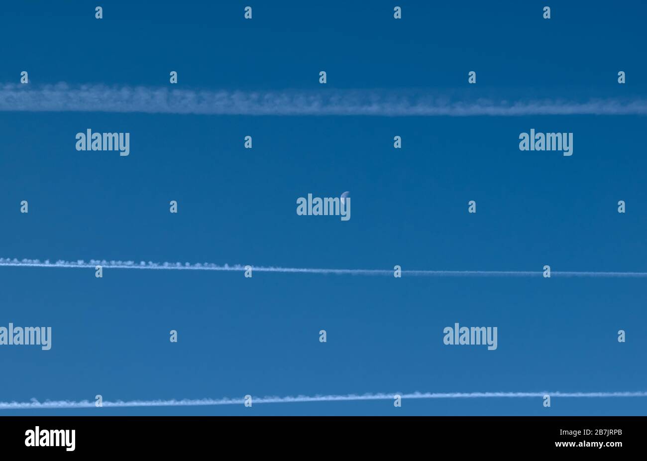 Daylight Moon and Contrails Stock Photo - Alamy