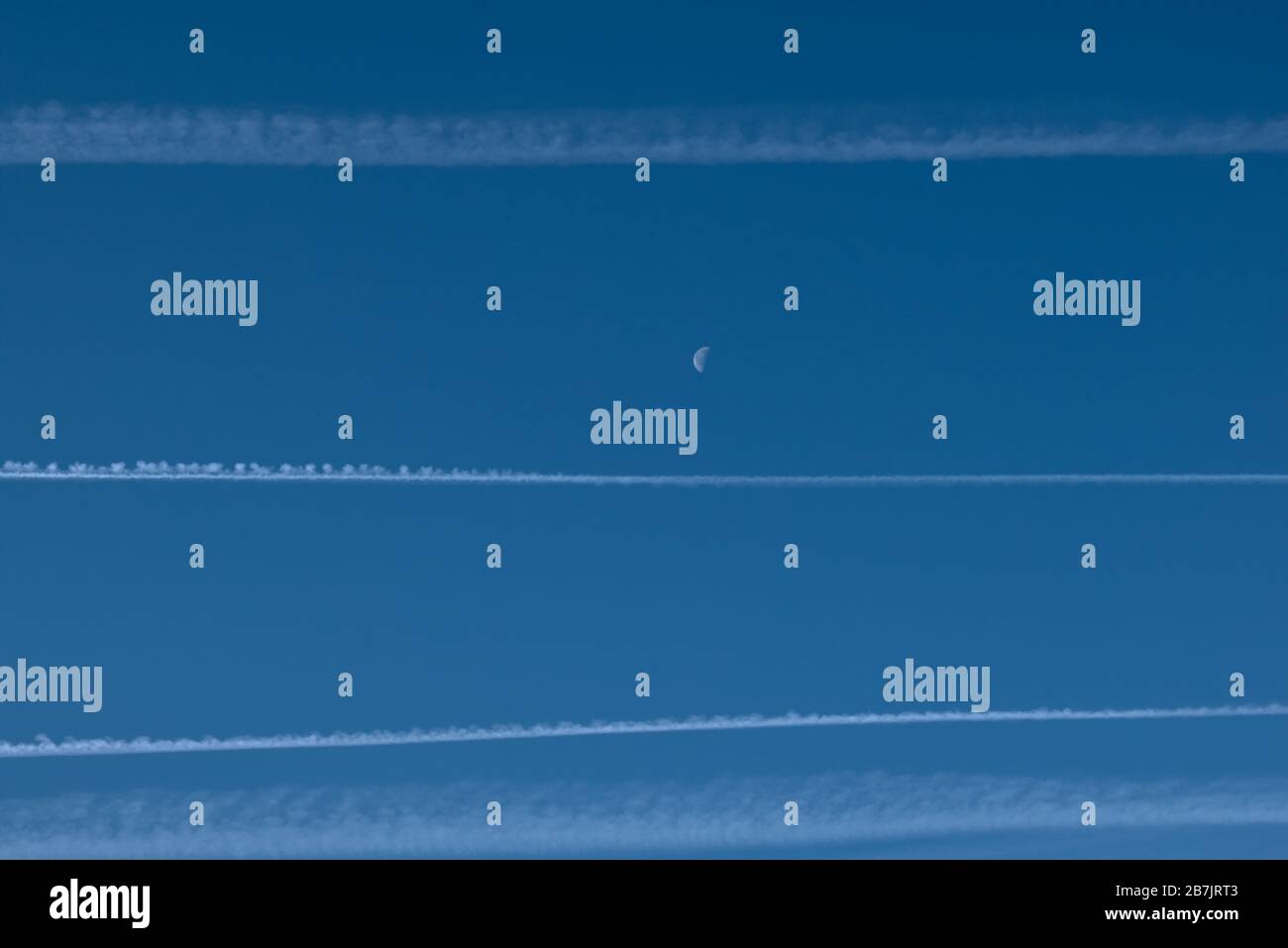 Daylight Moon and Contrails Stock Photo - Alamy