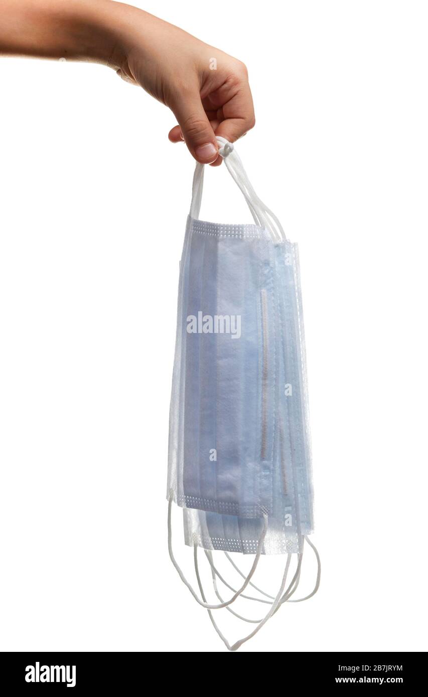 medical masks in hand on a white background isolate Stock Photo - Alamy