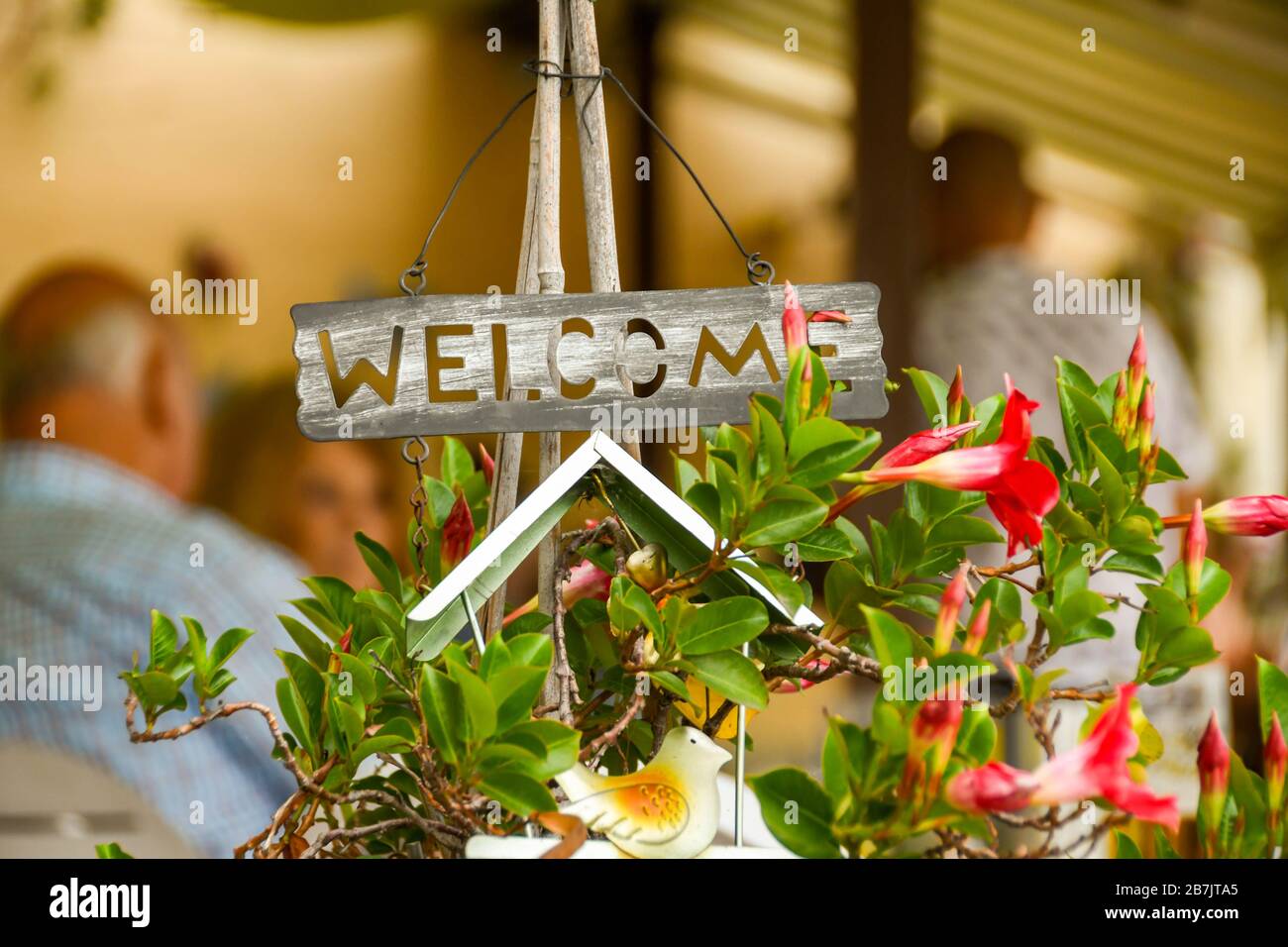 LAKE COMO, ITALY - JUNE 2019: A "Welcome" sign carved out of wood ...
