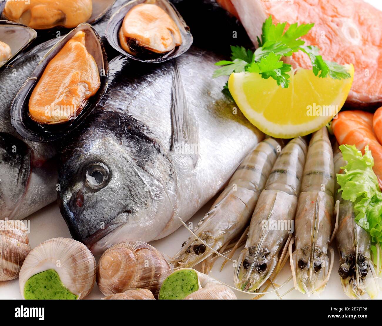 Fresh fish and prawns on display at a fish mongers Stock Photo - Alamy
